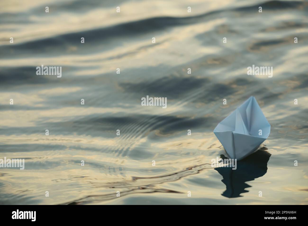 Paper boat floating on water outdoors. Space for text Stock Photo - Alamy