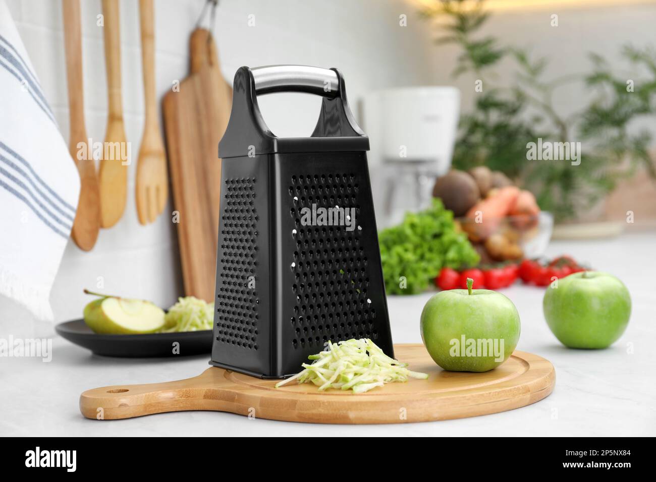Grater and fresh ripe apples on kitchen counter Stock Photo - Alamy