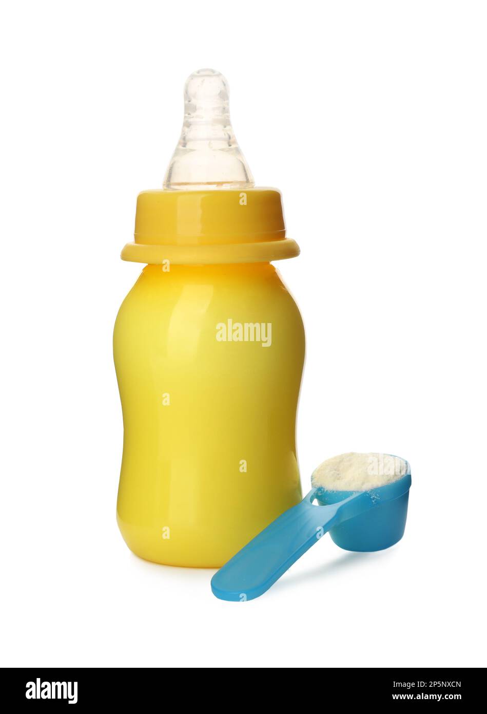 Feeding bottle with infant formula and scoop of powder on white ...