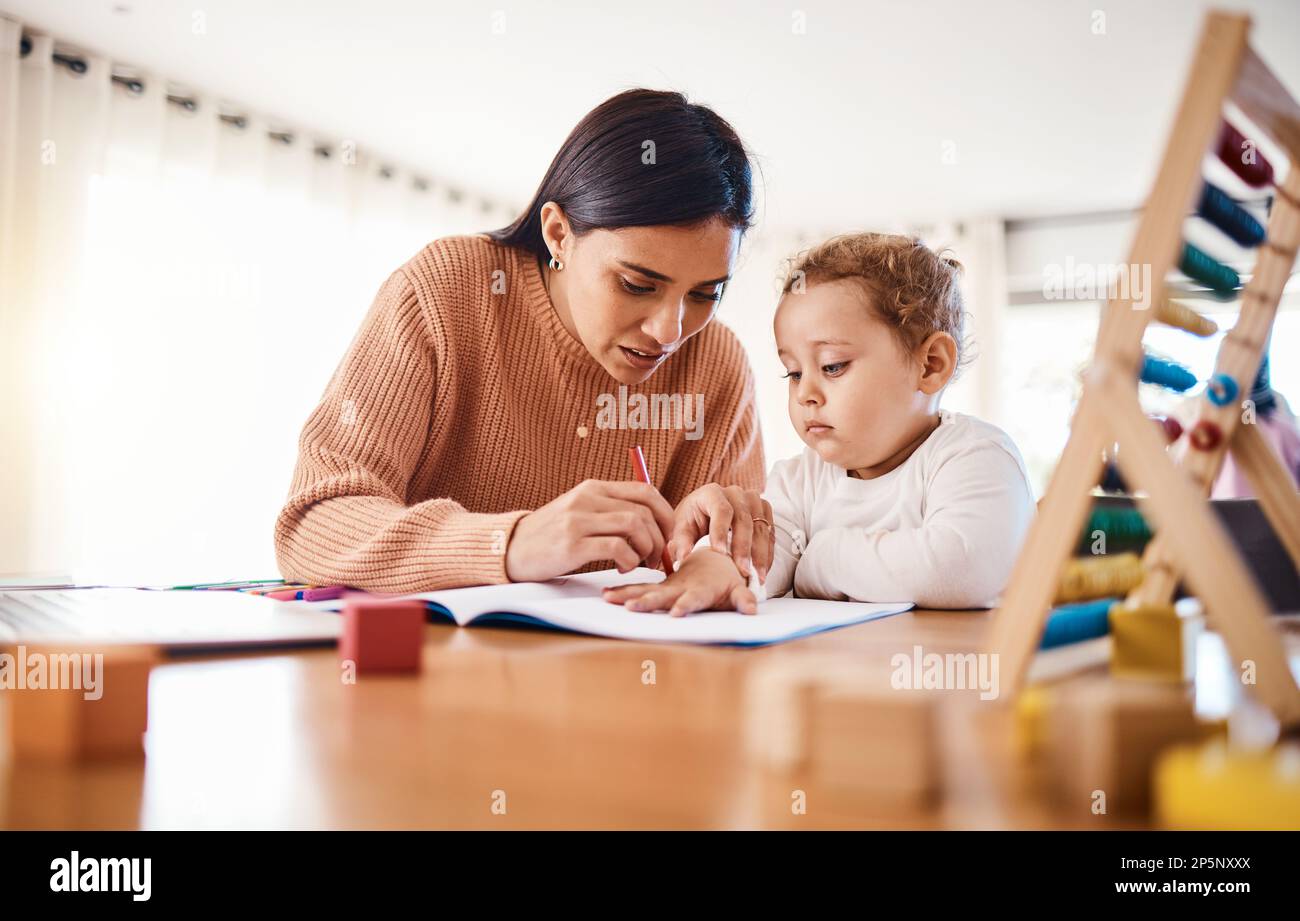 Education, learning and mother with child drawing in book in home for ...