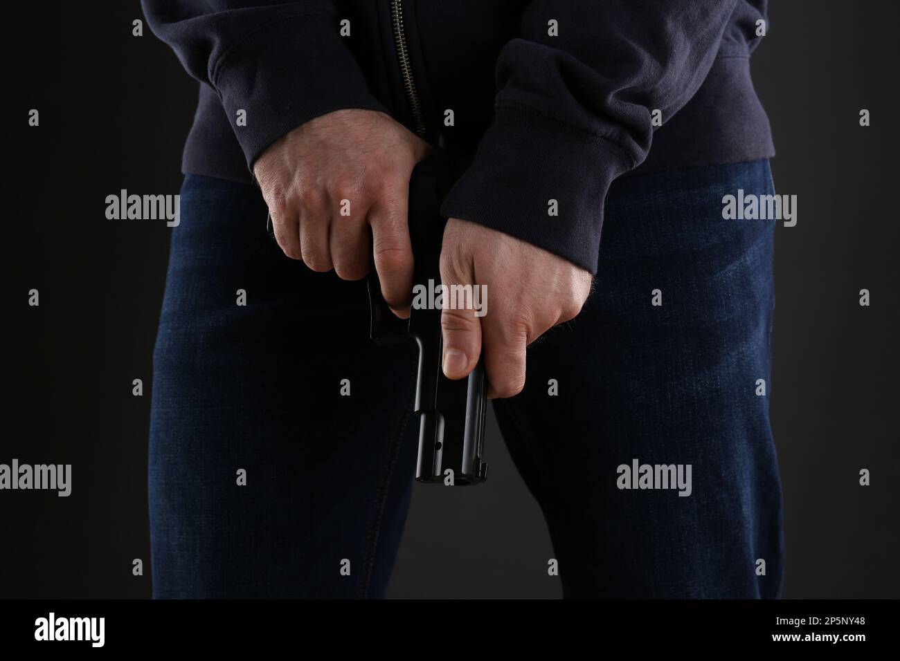 Man reloading gun on black background, closeup Stock Photo - Alamy