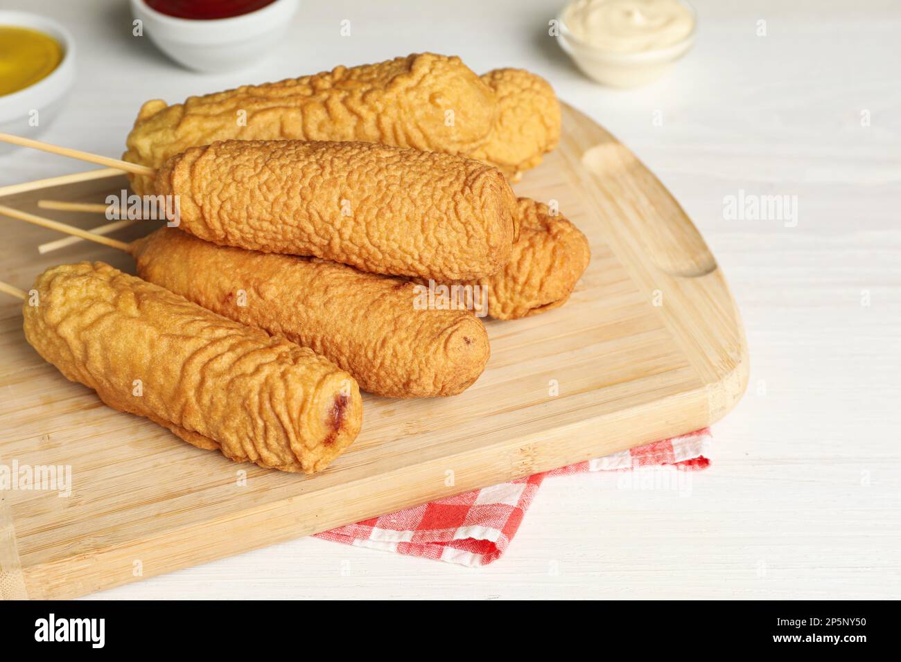 Delicious deep fried corn dogs on white wooden table Stock Photo - Alamy