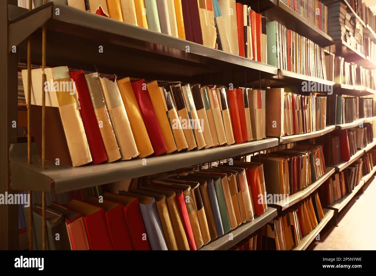 Collection of different books on shelves in library Stock Photo - Alamy