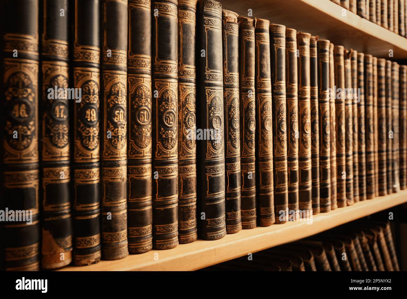 Collection of old books on shelf in library Stock Photo - Alamy
