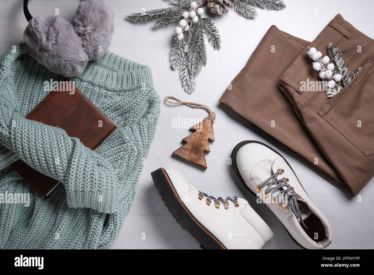 Winter fashion. Layout of women's outfit on light grey background, top ...