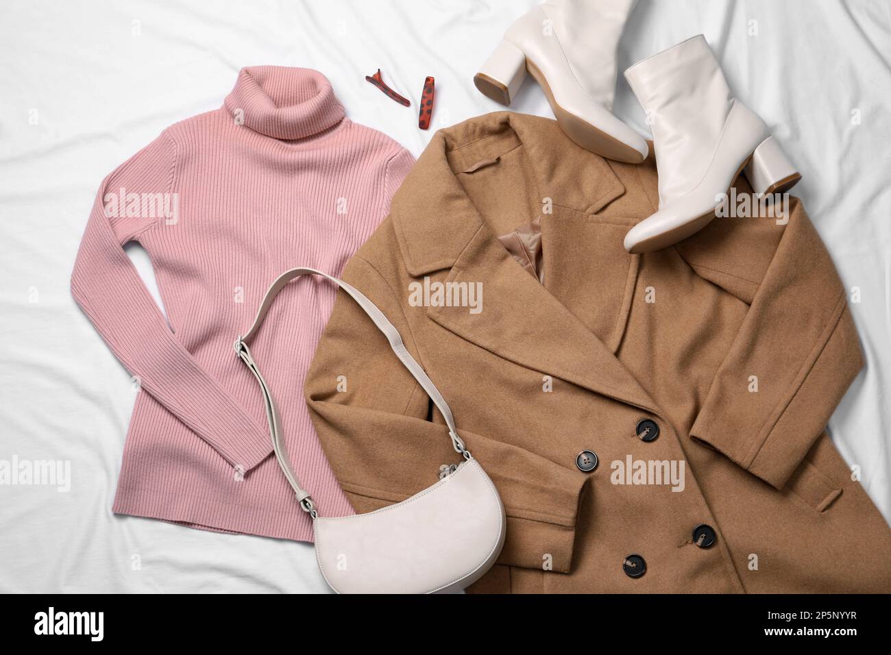 Fall fashion. Layout with women's outfit on white fabric, top view ...