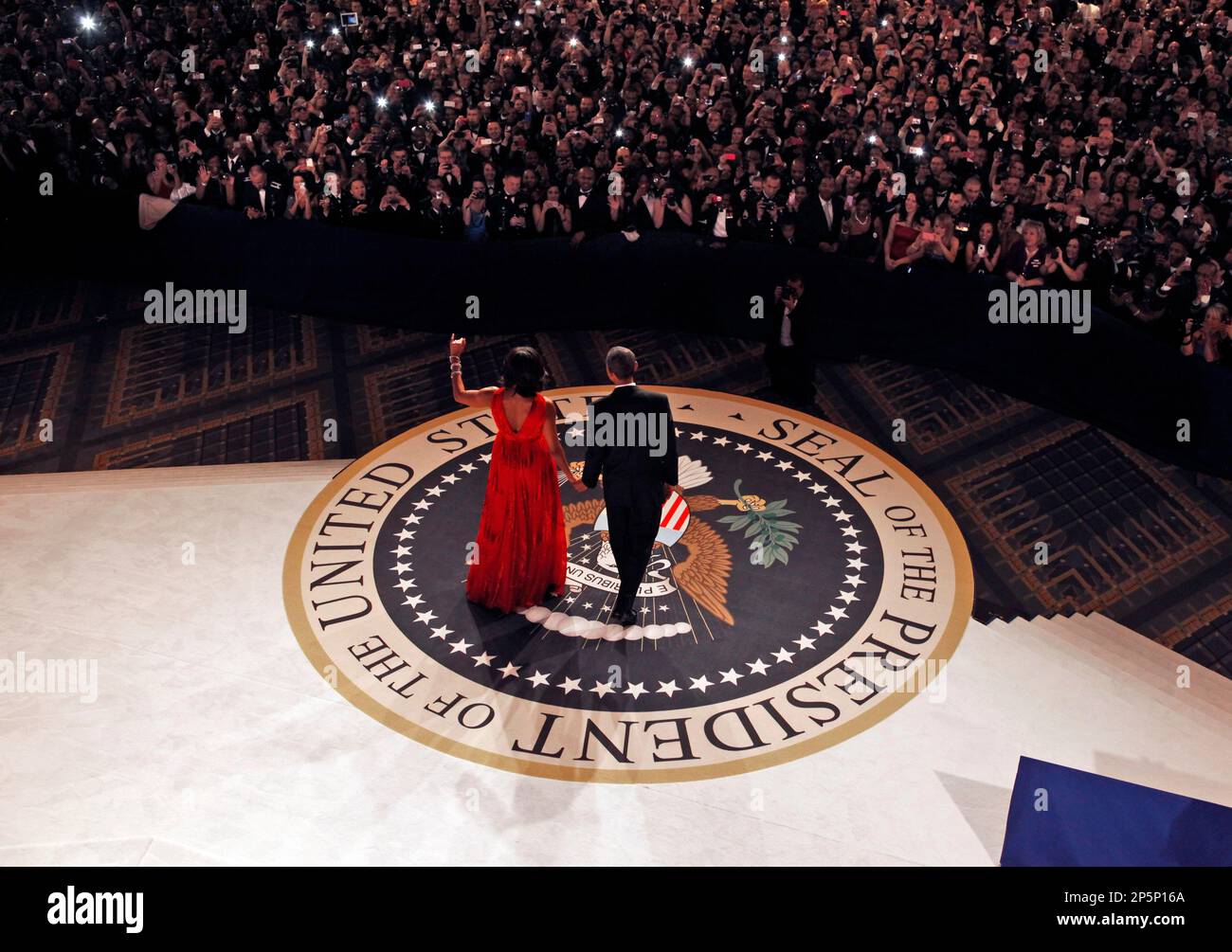 President Barack Obama and first lady Michelle Obama walk on stage for ...