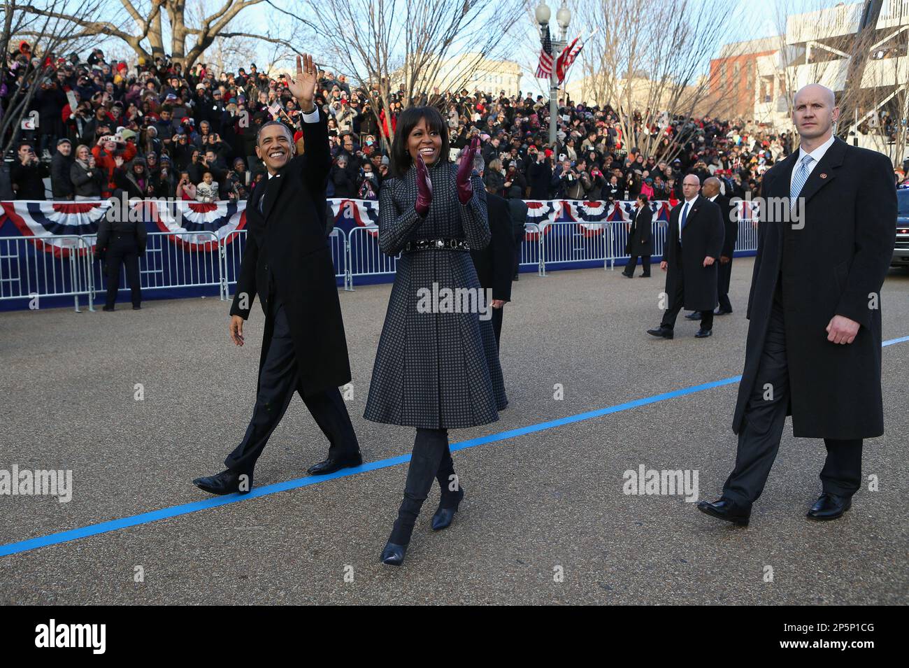 President Barack Obama and first lady Michelle Obama wave as they walk ...