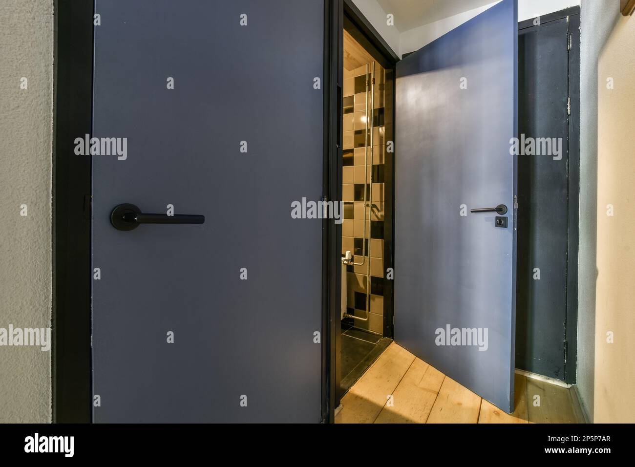 an open door in a room with wood flooring and wallpapers on the walls ...