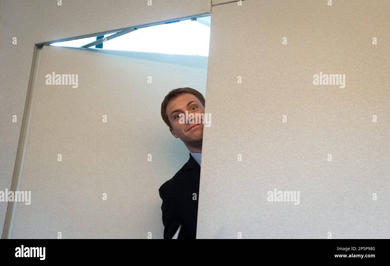 B.C. Lions quarterback Travis Lulay looks in at assembled media from a ...