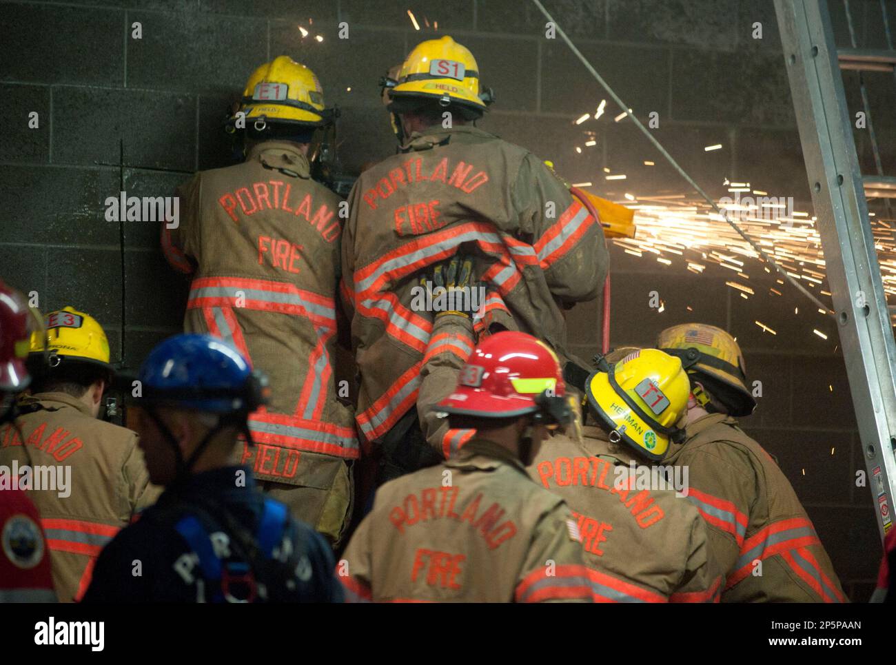 Firefighters work to free a woman who fell part of the way down the 20 ...