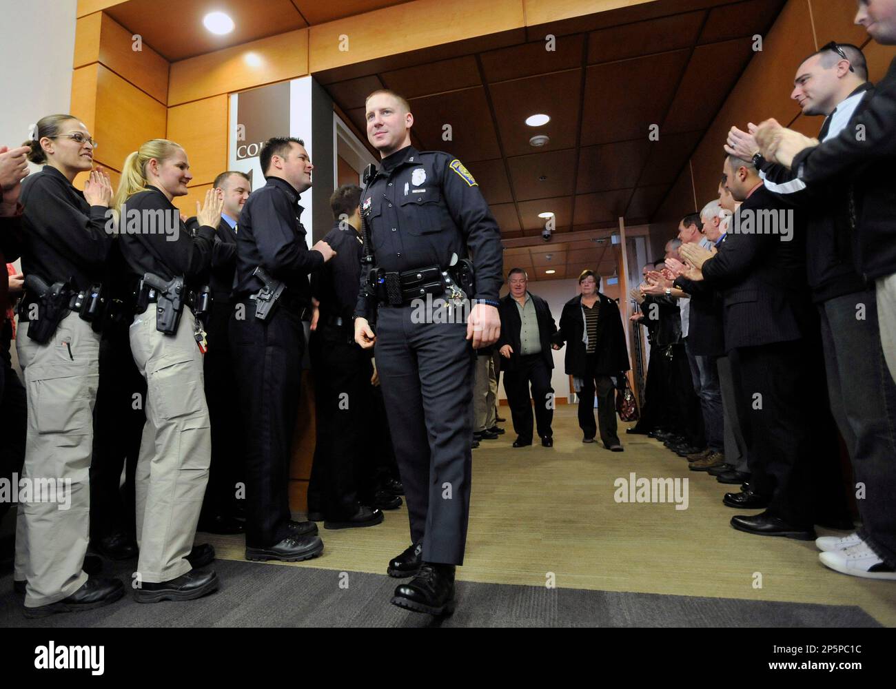 Manchester Police Officer Daniel Doherty walks through a gauntlet of ...