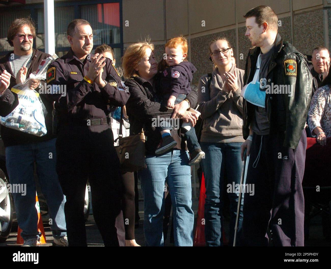 Norwich police officer Jonathan Ley, right, who was shot four times ...