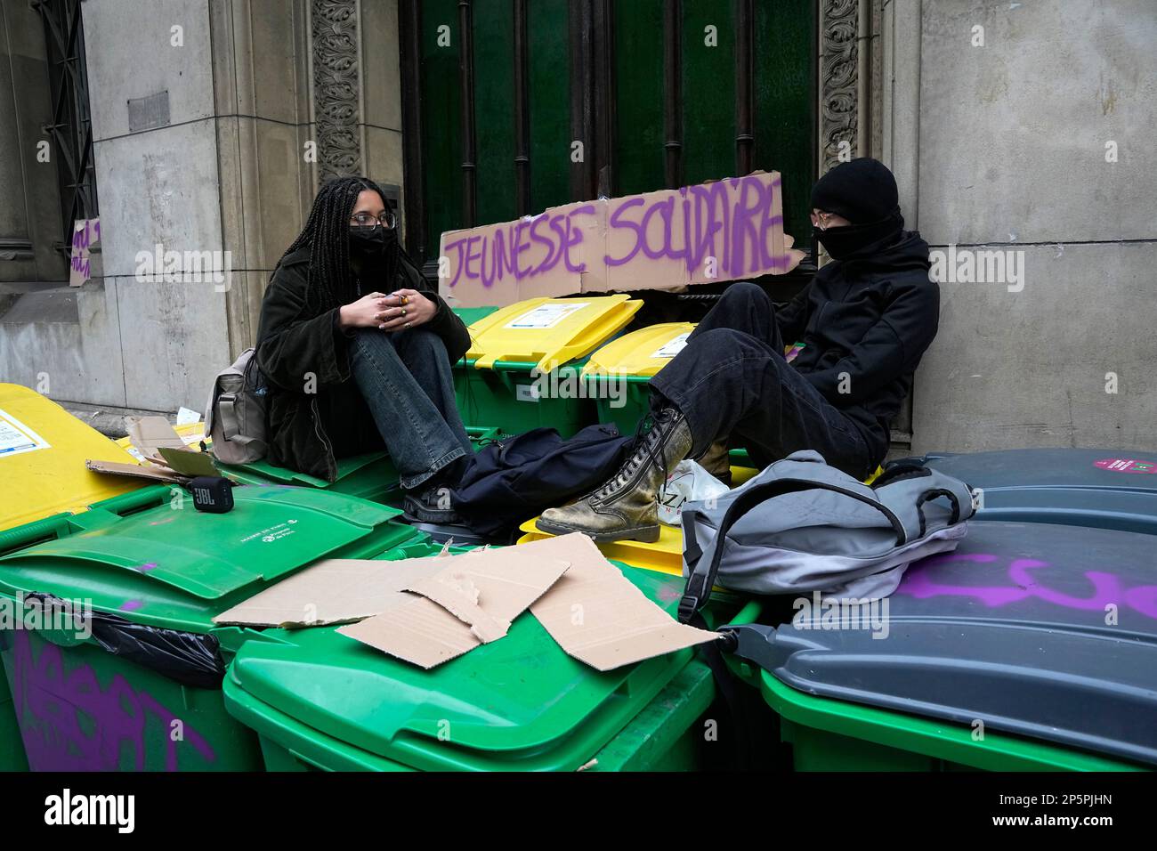 Striking students sit on garbage cans outside their high school Tuesday ...