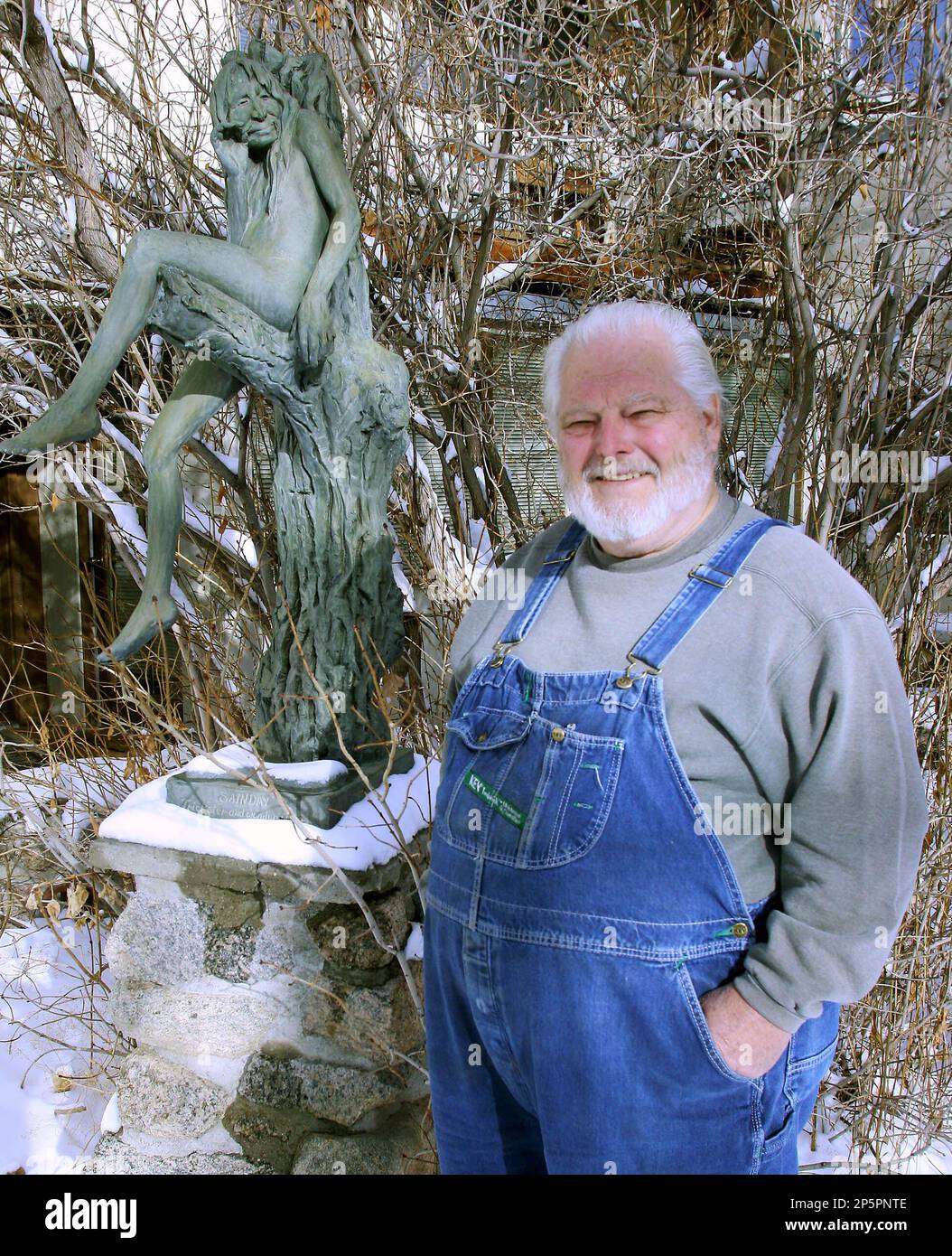 Sculptor Richard Greeves stands near one of his statues of a mystical ...