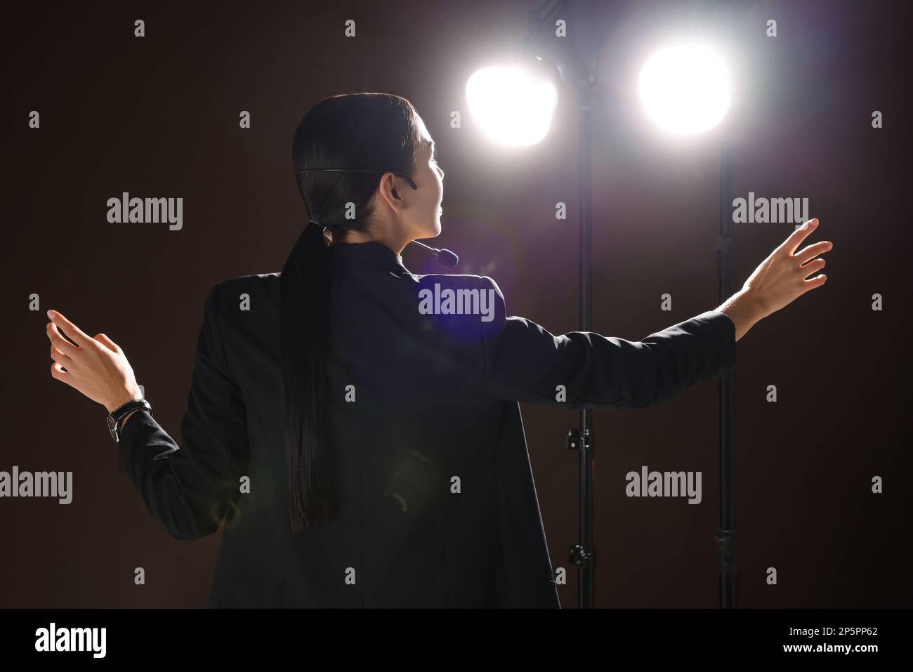 Motivational speaker with headset performing on stage, back view Stock ...