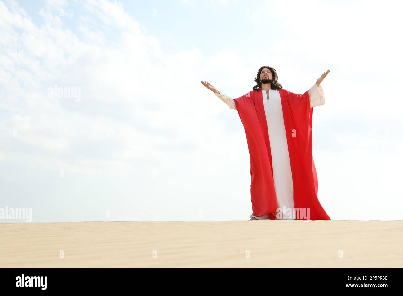 Jesus Christ raising hands in desert. Space for text Stock Photo - Alamy