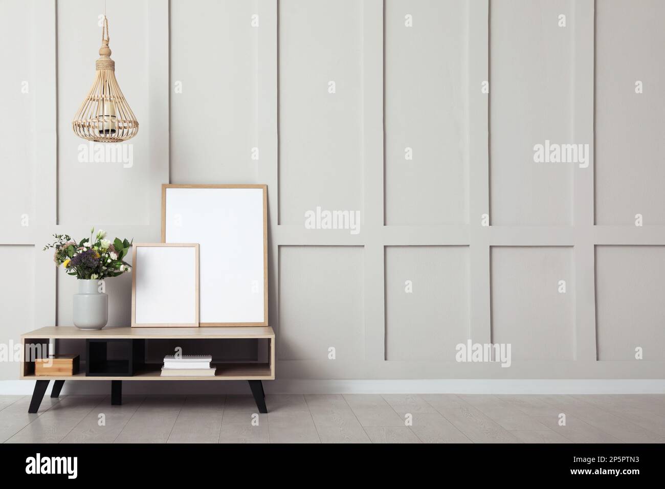 Simple room interior with console table, decor elements and empty wall ...