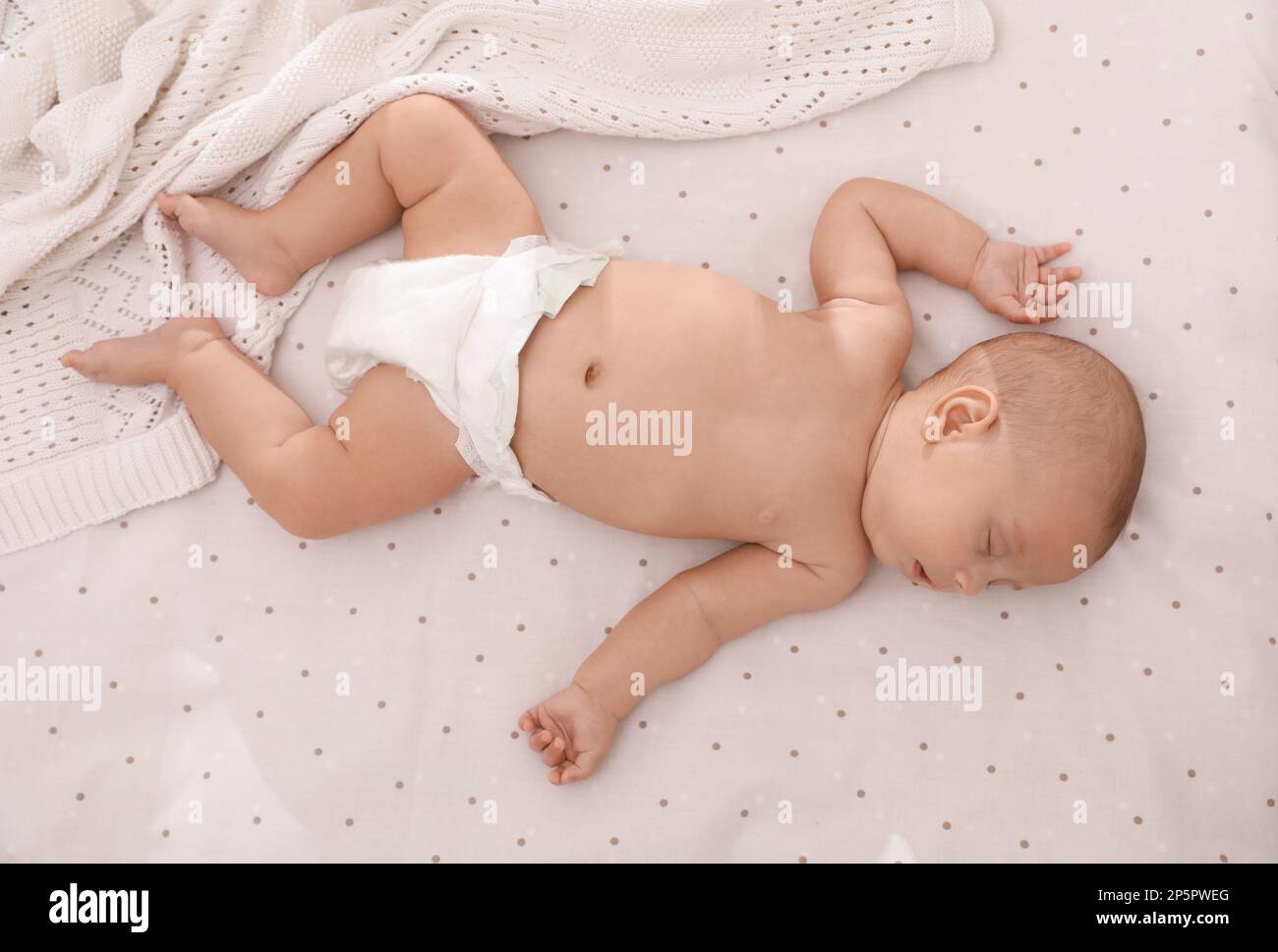 Cute little baby in diaper sleeping on bed, top view Stock Photo - Alamy