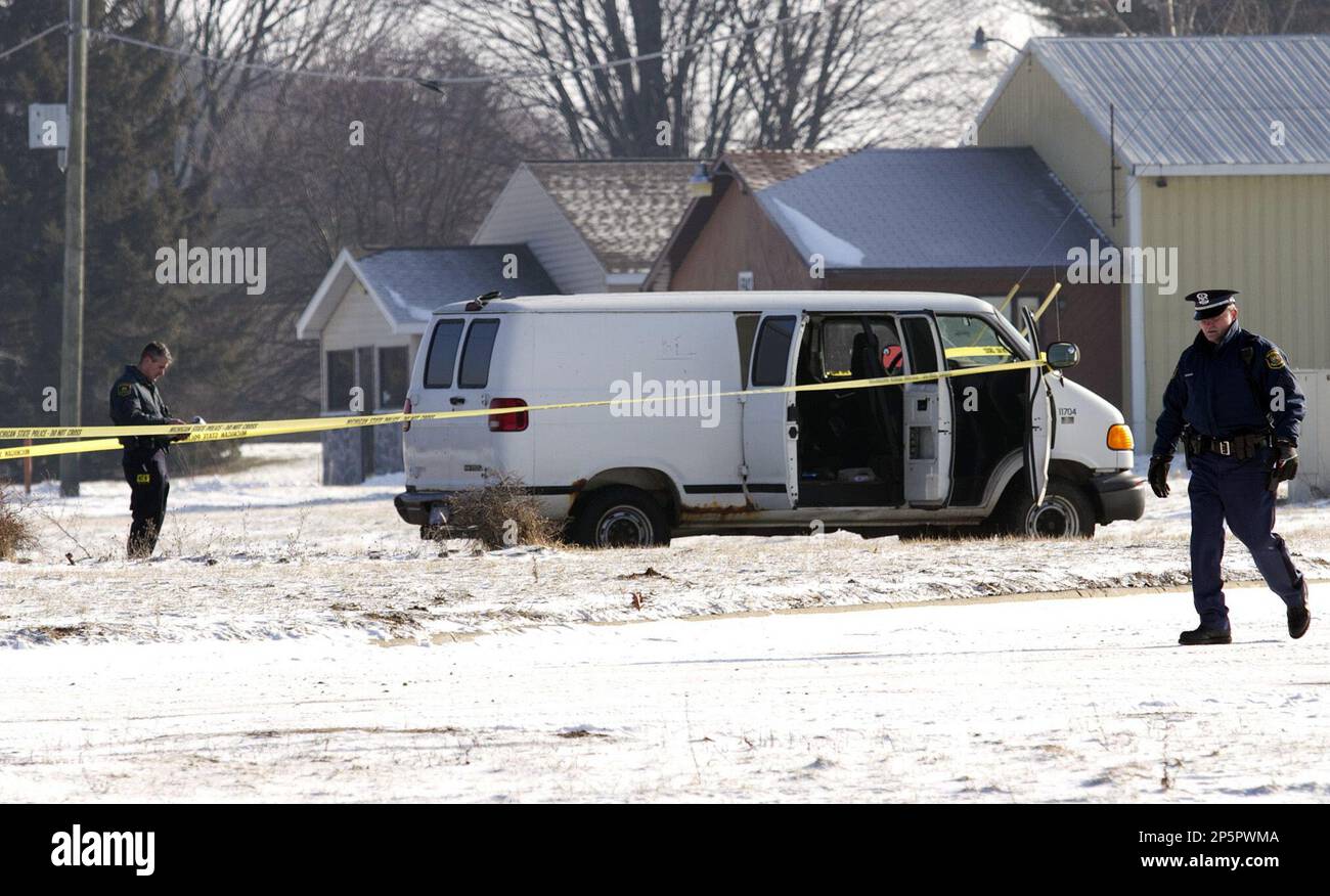 Police investigate the scene where a Belding police officer shot and ...