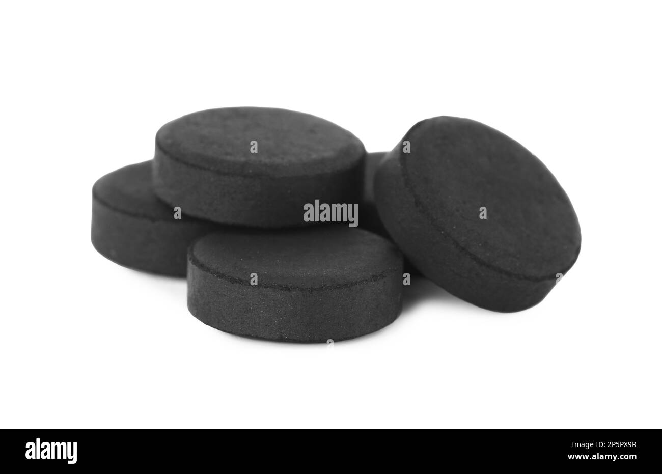 Activated charcoal pills on white background. Potent sorbent Stock ...