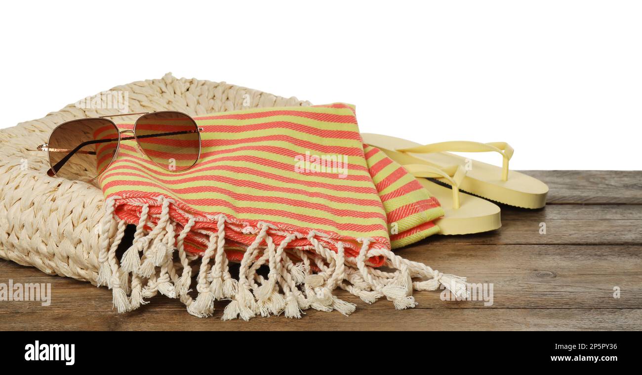 Beach bag with towel, flip flops and sunglasses on wooden surface ...