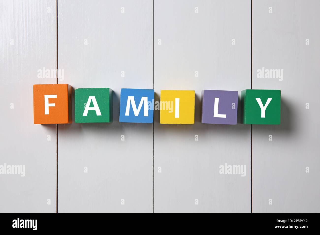 Colorful cubes with word Family on white wooden background, flat lay ...