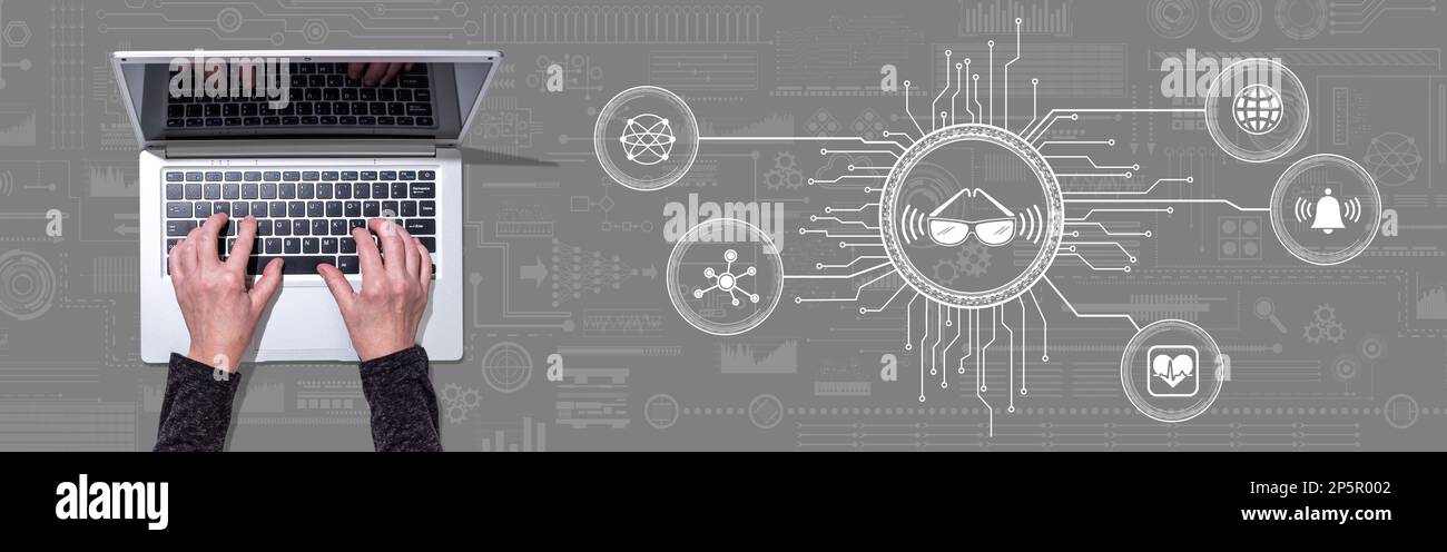 Top view of hands using laptop with symbol of smart glasses concept ...