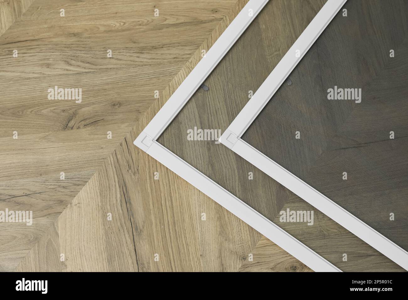 New window screens on wooden floor, flat lay. Space for text Stock ...