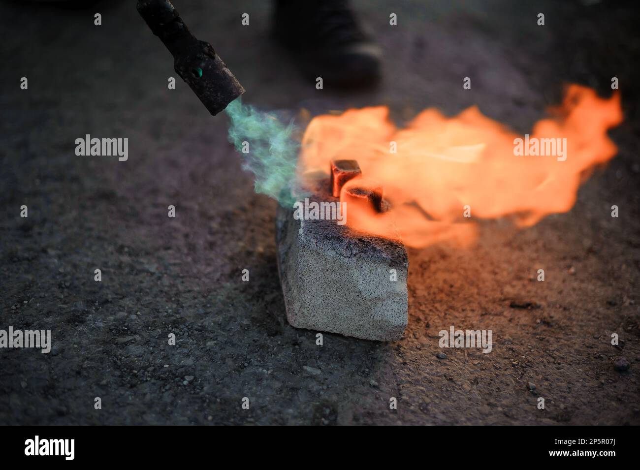 Coal on fire. Ignition of square coal with a gas burner Stock Photo - Alamy
