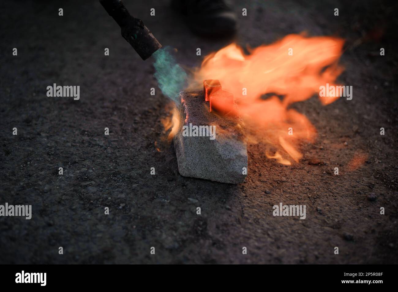 Coal on fire. Ignition of square coal with a gas burner Stock Photo - Alamy