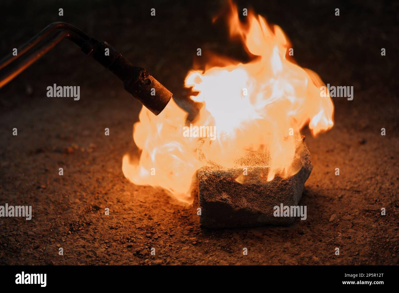 Coal on fire. Ignition of square coal with a gas burner Stock Photo - Alamy