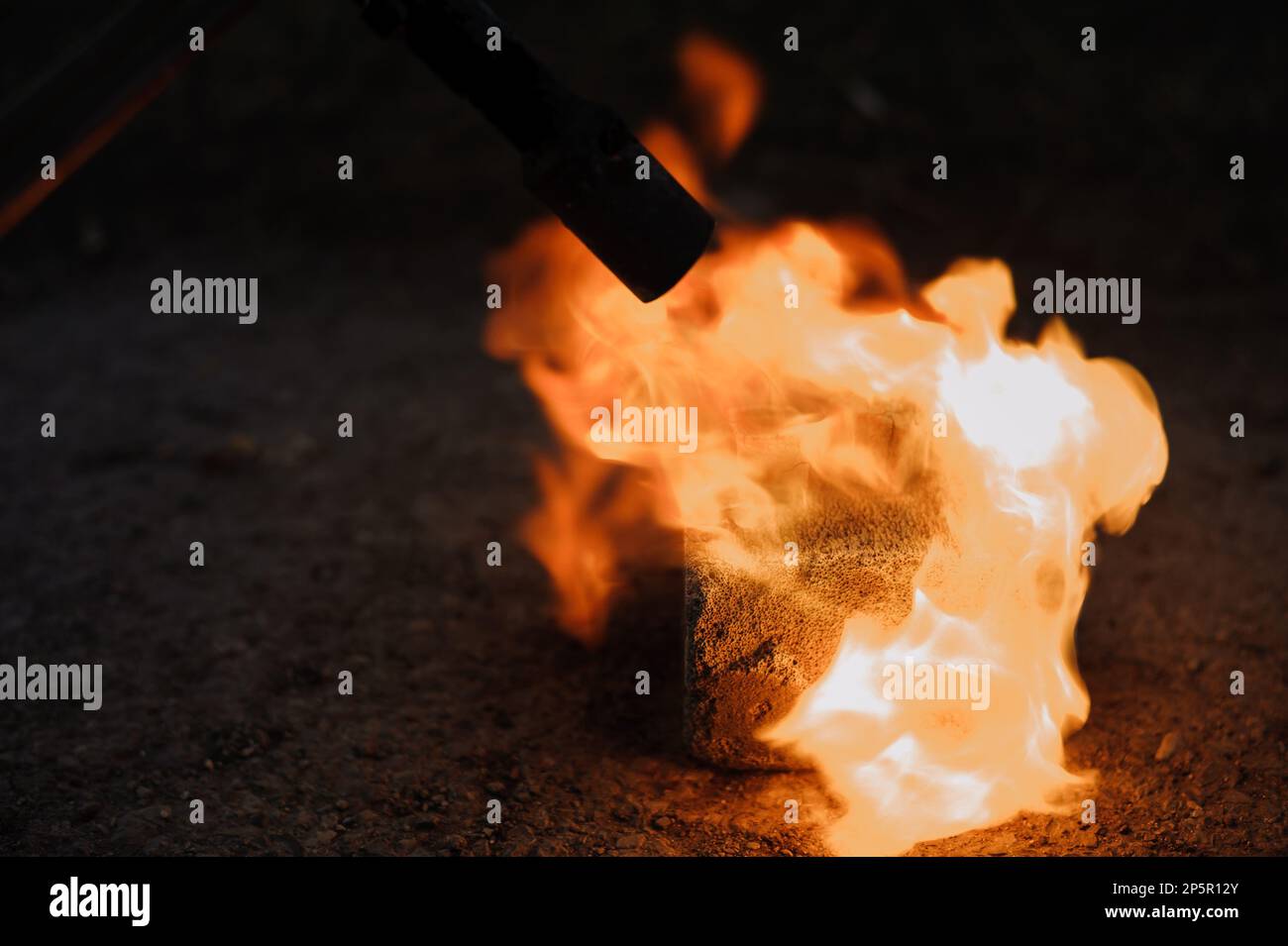 Coal on fire. Ignition of square coal with a gas burner Stock Photo - Alamy