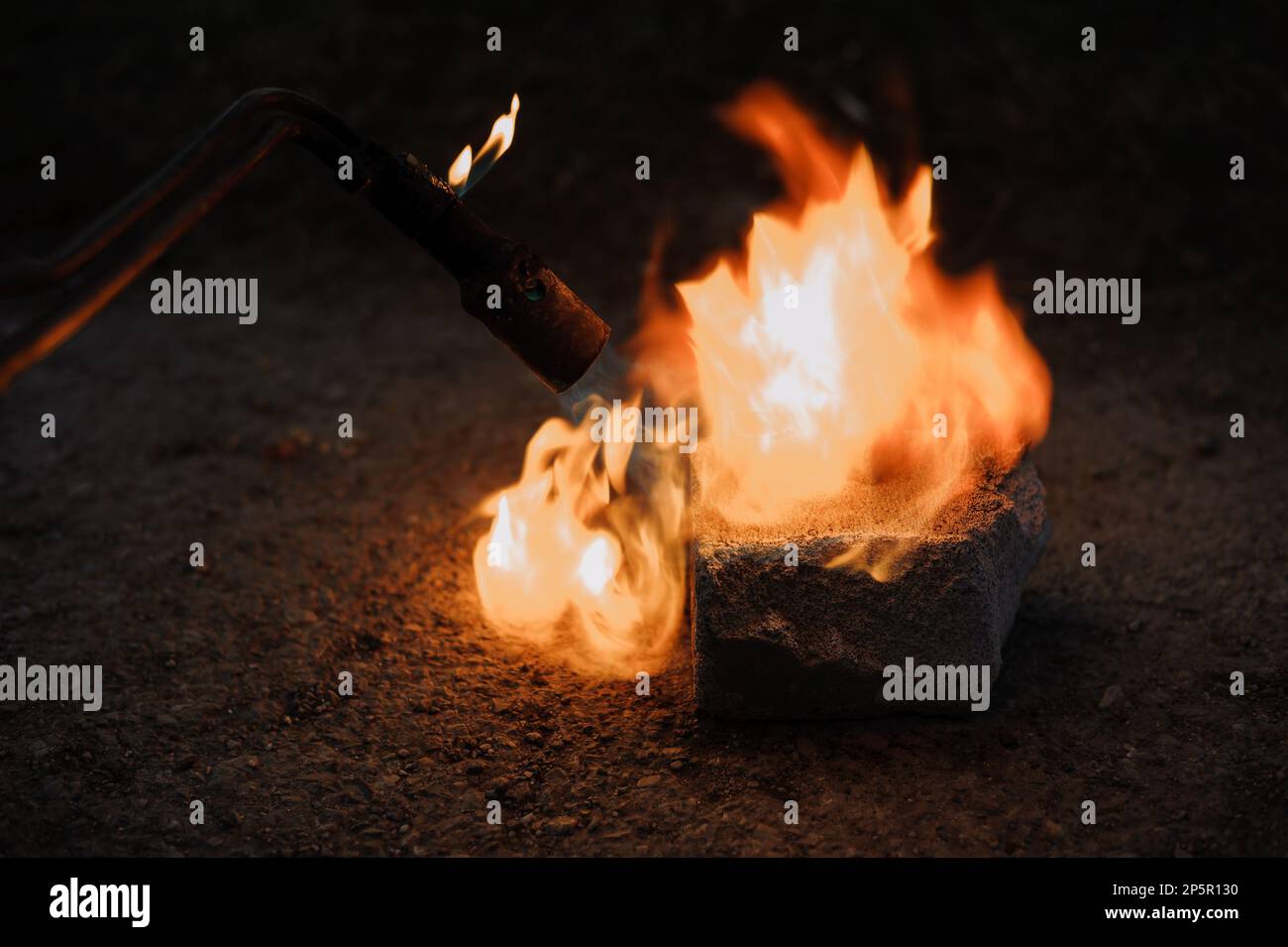 Coal on fire. Ignition of square coal with a gas burner Stock Photo - Alamy