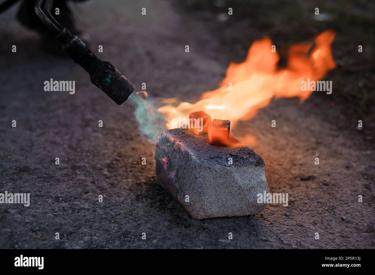 Coal on fire. Ignition of square coal with a gas burner Stock Photo - Alamy