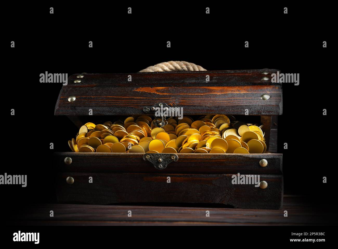 Open treasure chest with gold coins on wooden table Stock Photo - Alamy