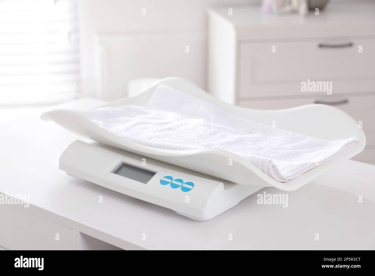 Modern digital baby scales on table in room Stock Photo - Alamy