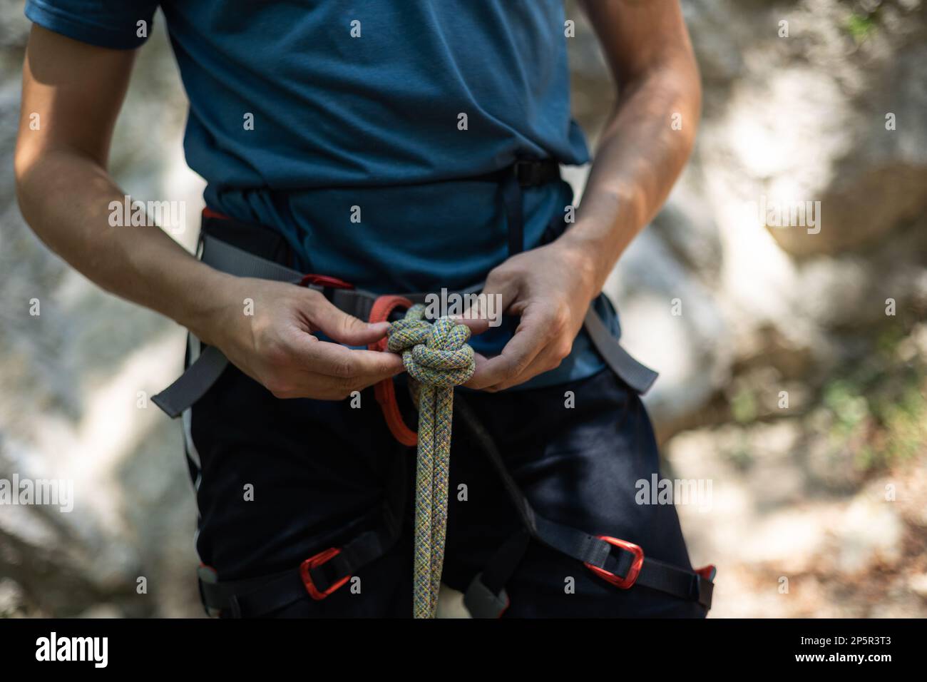 Close-up of male climber tied rope and preparing to climb Stock Photo ...