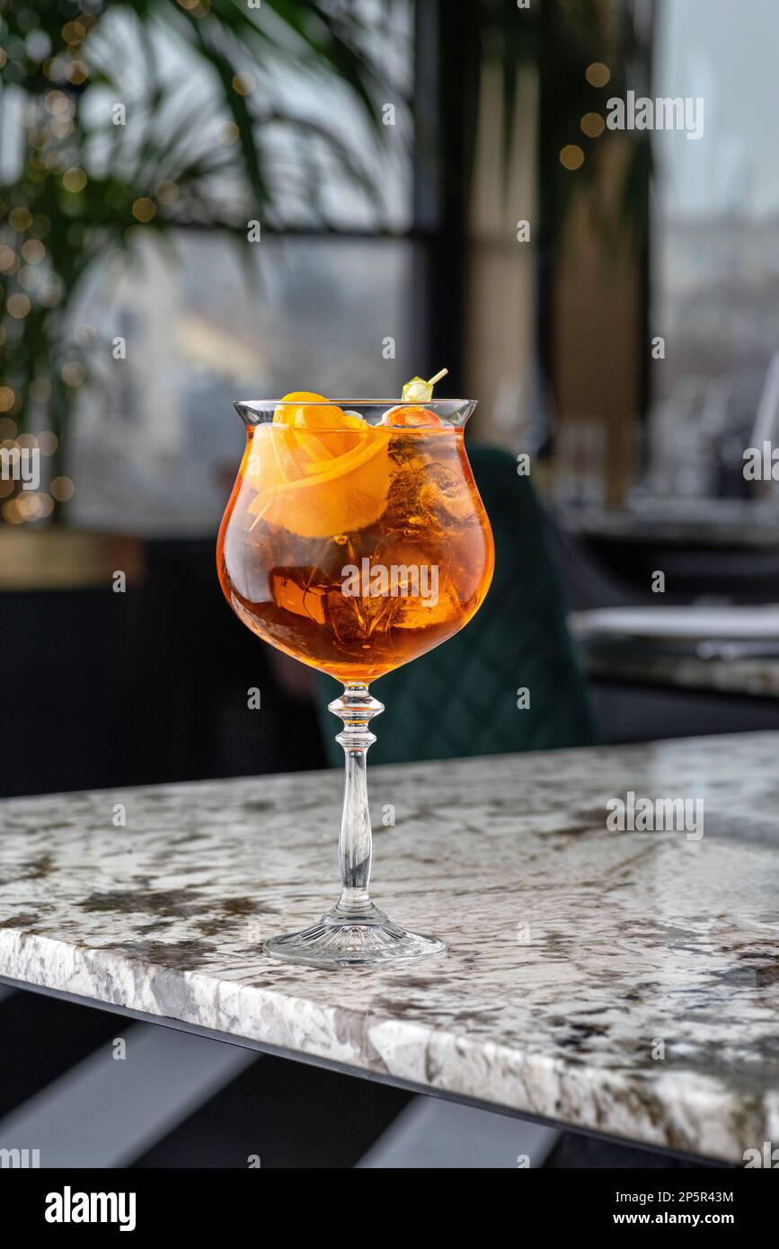 Aperol is an alcoholic cocktail. Orange. Cold drink with ice cubes. The ...
