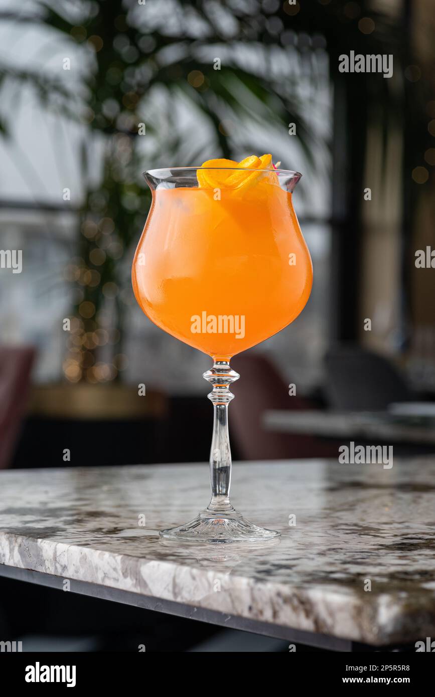 Aperol is an alcoholic cocktail. Orange. Cold drink with ice cubes. The ...