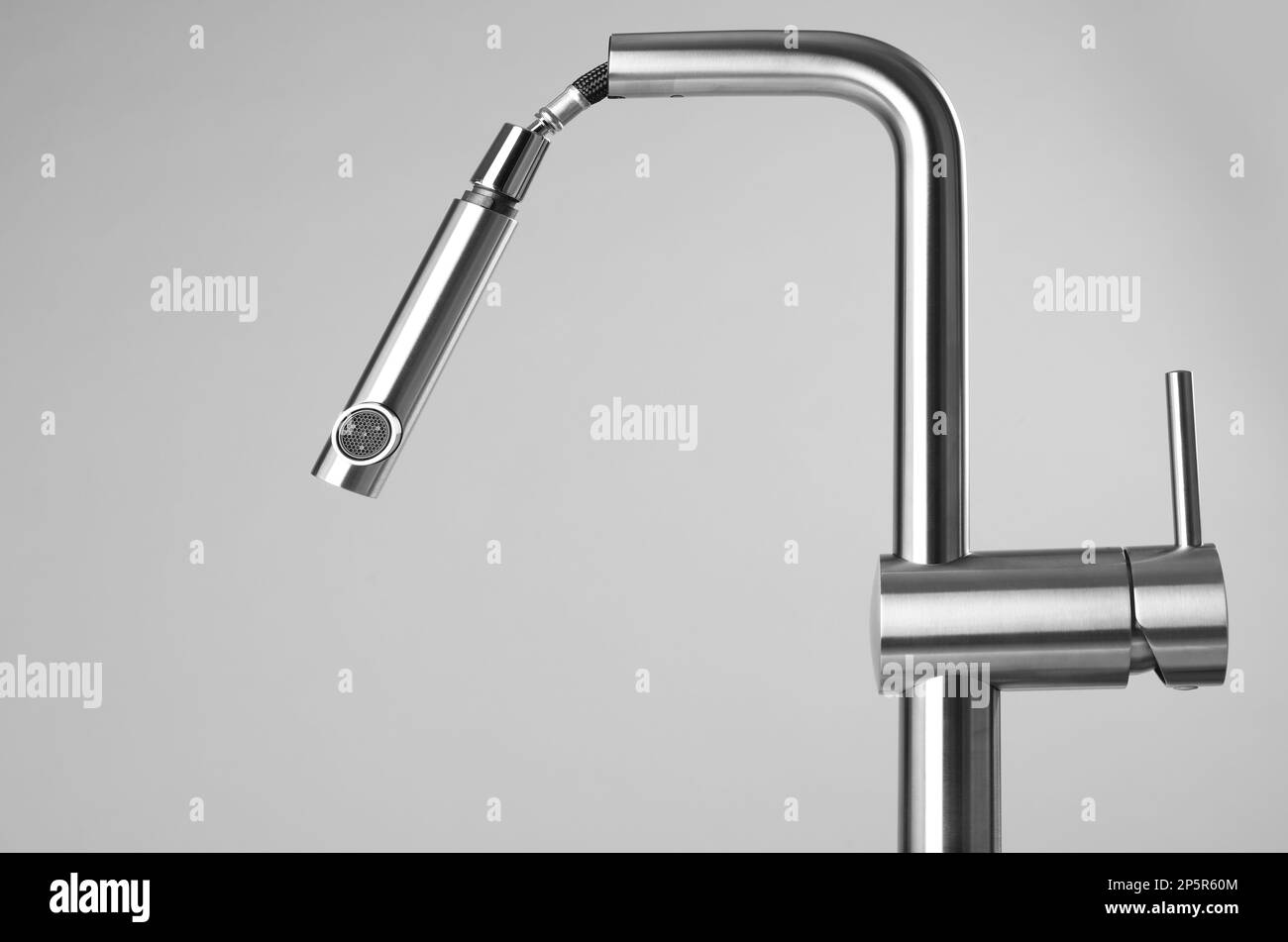 Modern pull out kitchen faucet on grey background Stock Photo - Alamy