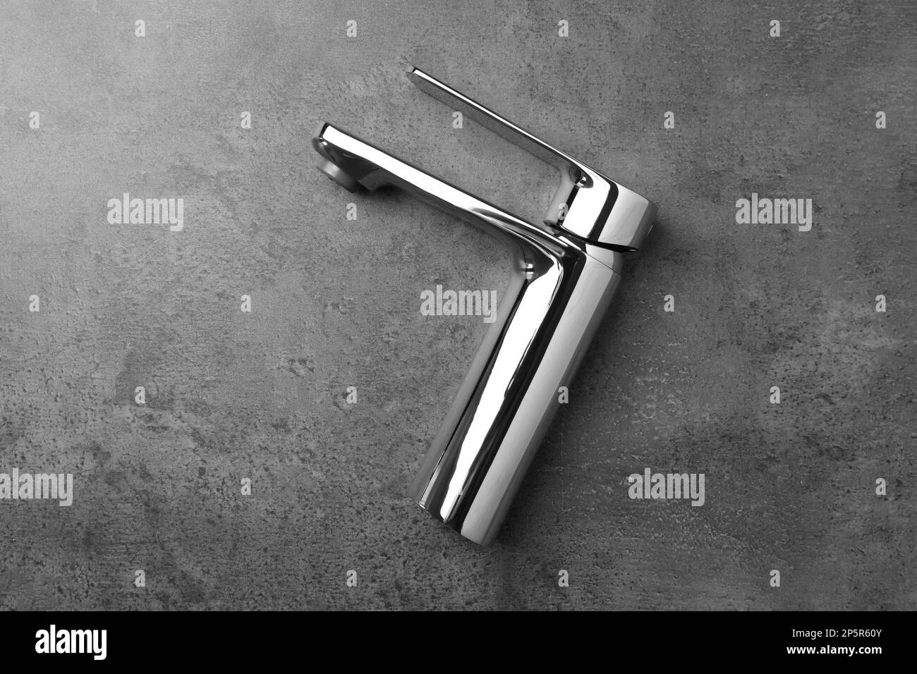 Single handle water tap on grey table, top view Stock Photo - Alamy