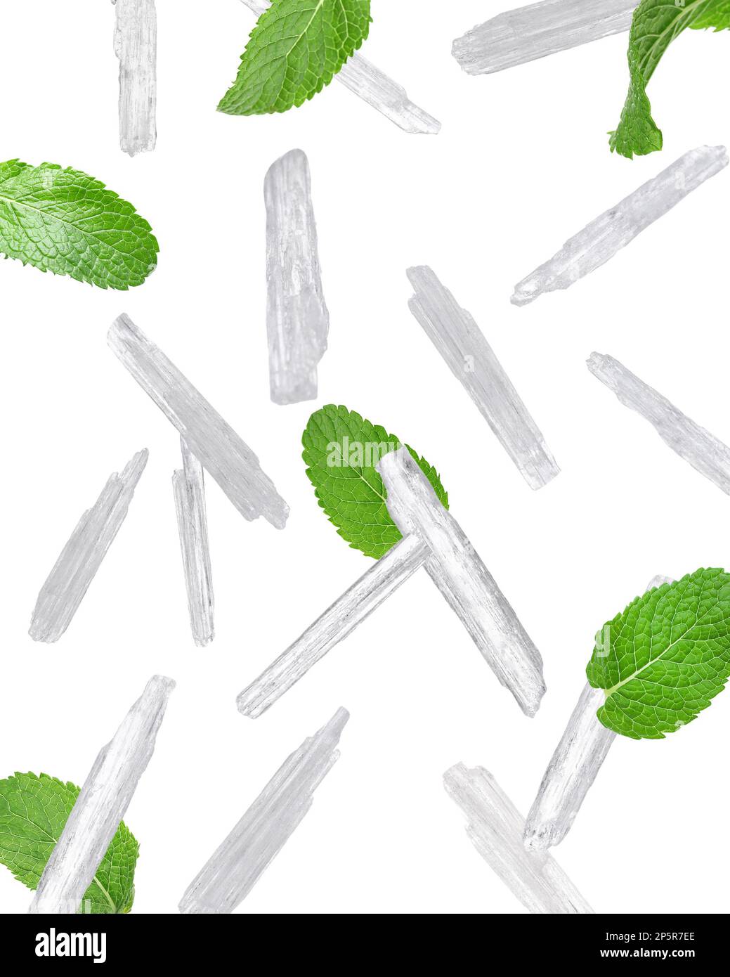 Translucent menthol crystals and green mint leaves falling on white ...