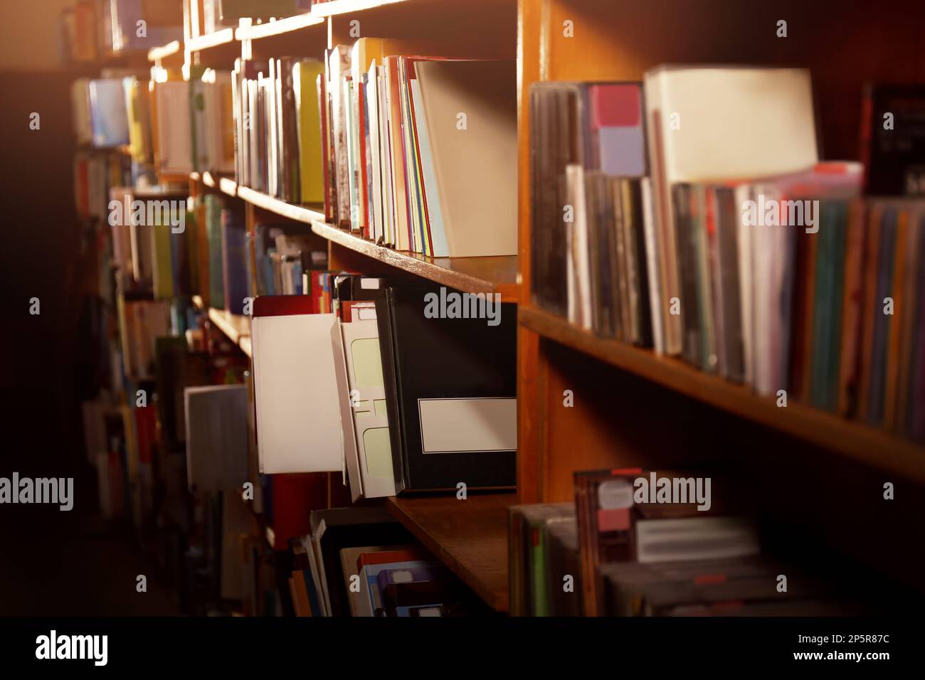 Collection of different books on shelves in library Stock Photo - Alamy