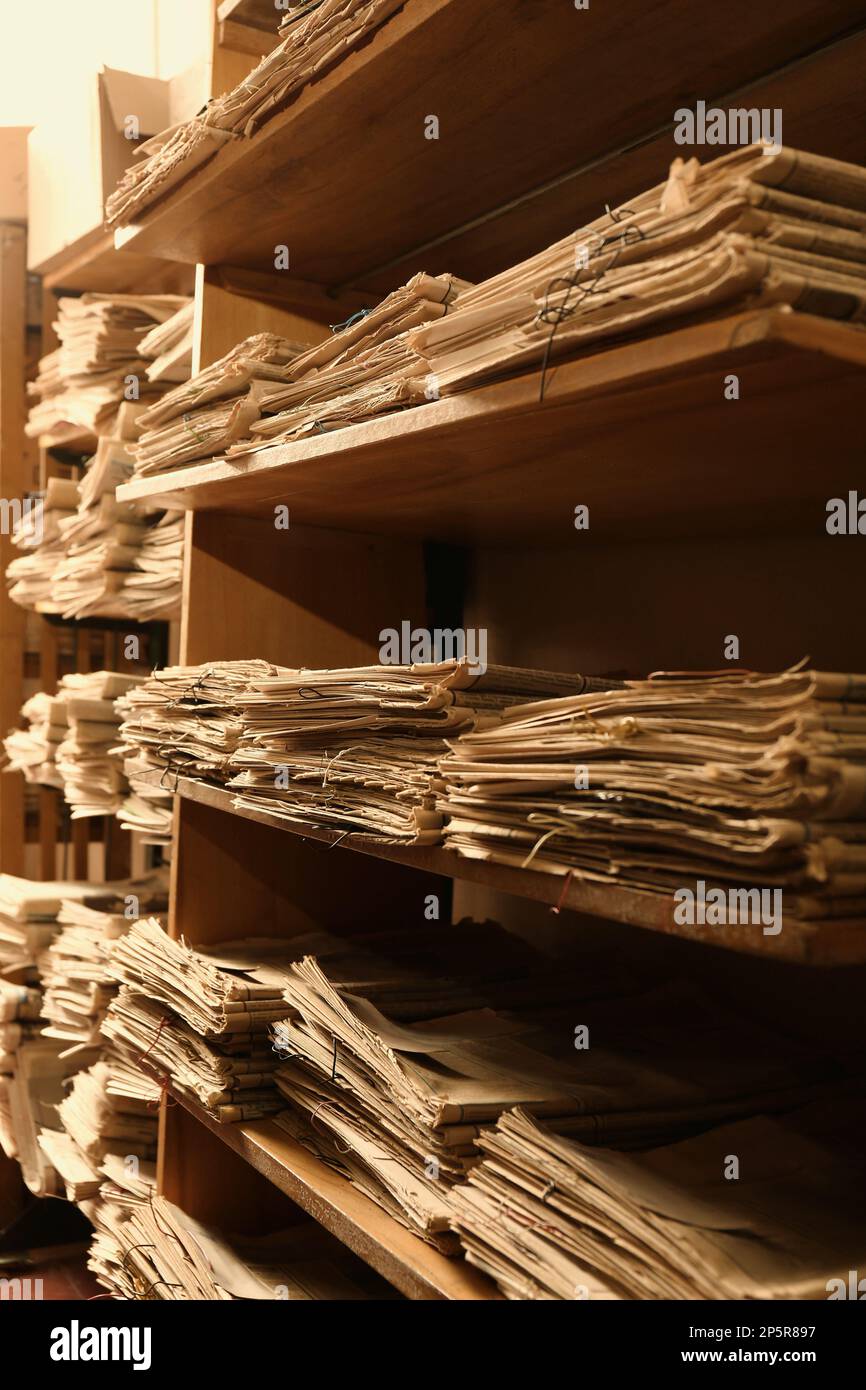 Collection of old newspapers on shelves in library Stock Photo - Alamy