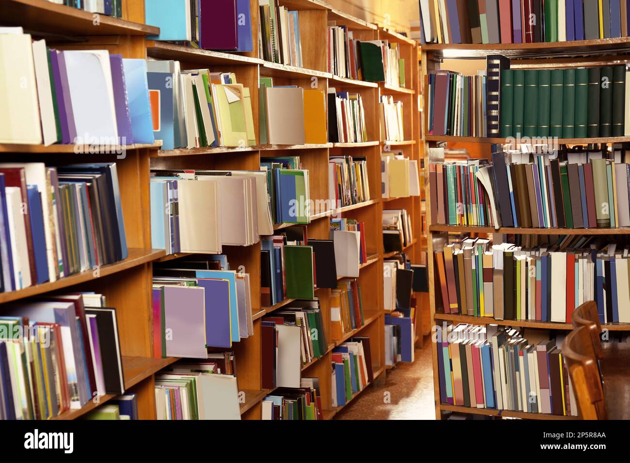 Collection of different books on shelves in library Stock Photo - Alamy