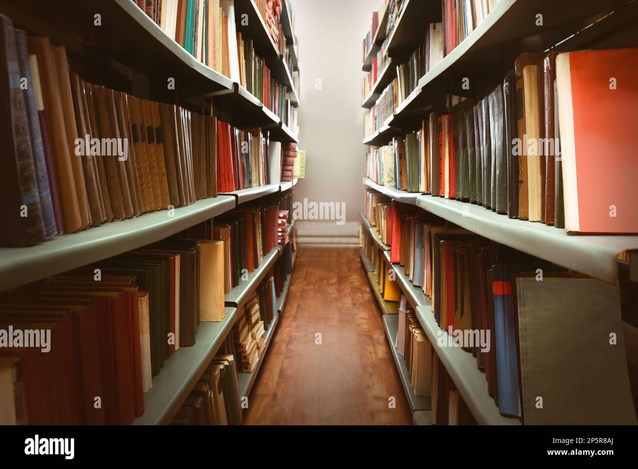 Collection of different books on shelves in library Stock Photo - Alamy