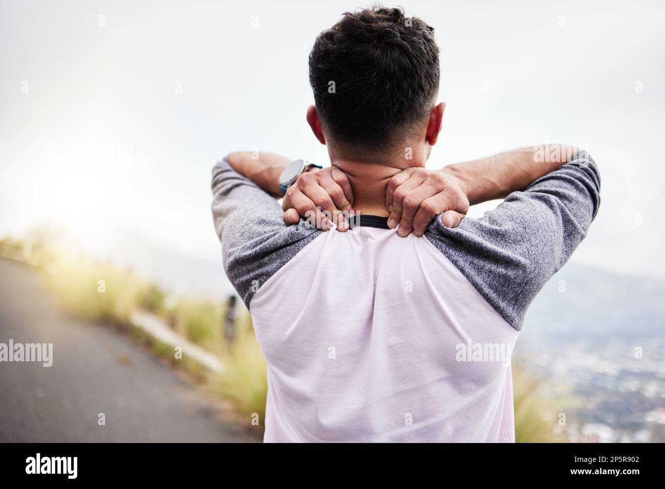 Neck pain, fitness and athlete of a man on a road for workout, running ...