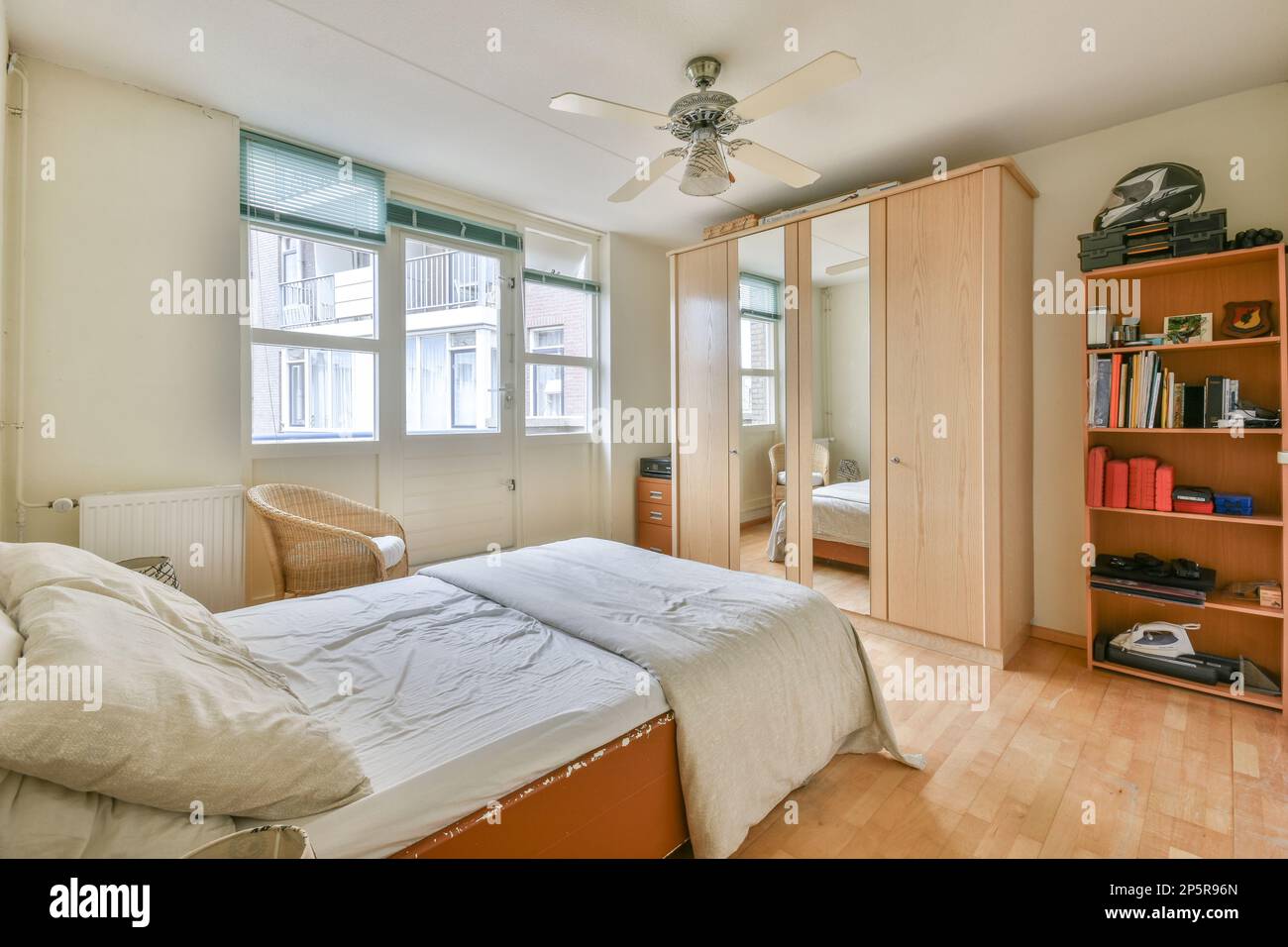 a bedroom with a bed, bookcases and books on the shelves in front of ...