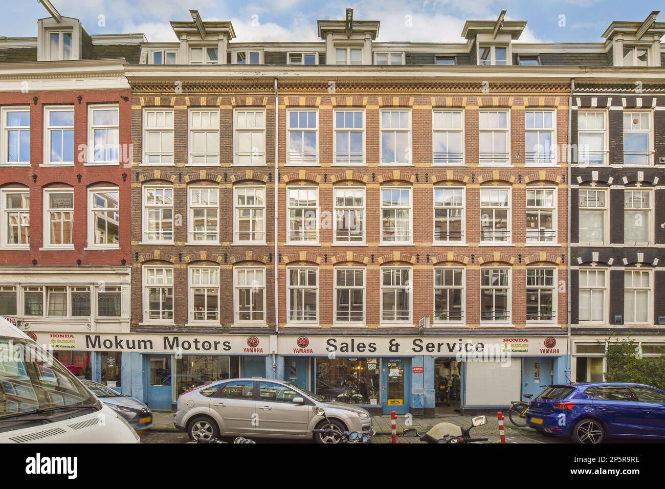 some cars parked in front of a building with the words mot's sales and ...